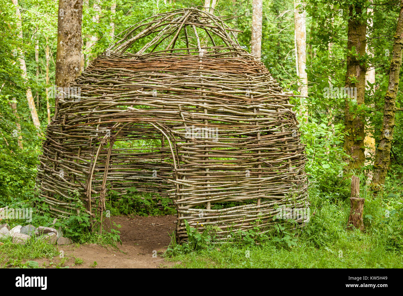 Tiny cottage made of wooden sticks in woods, hovel, shelter for small ...