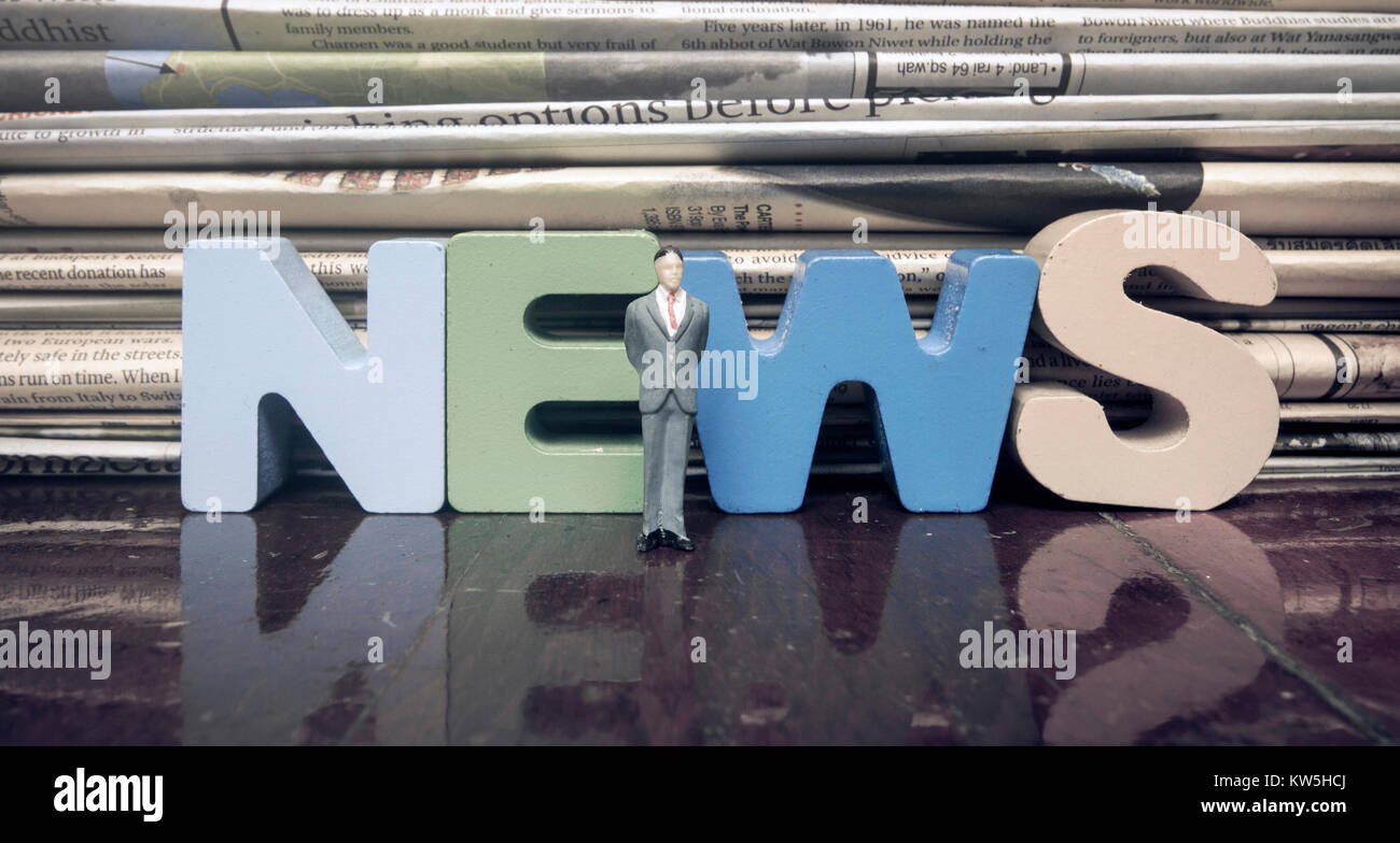 the word NEWS with wooden letters on a ple of old nespaper Stock Photo ...