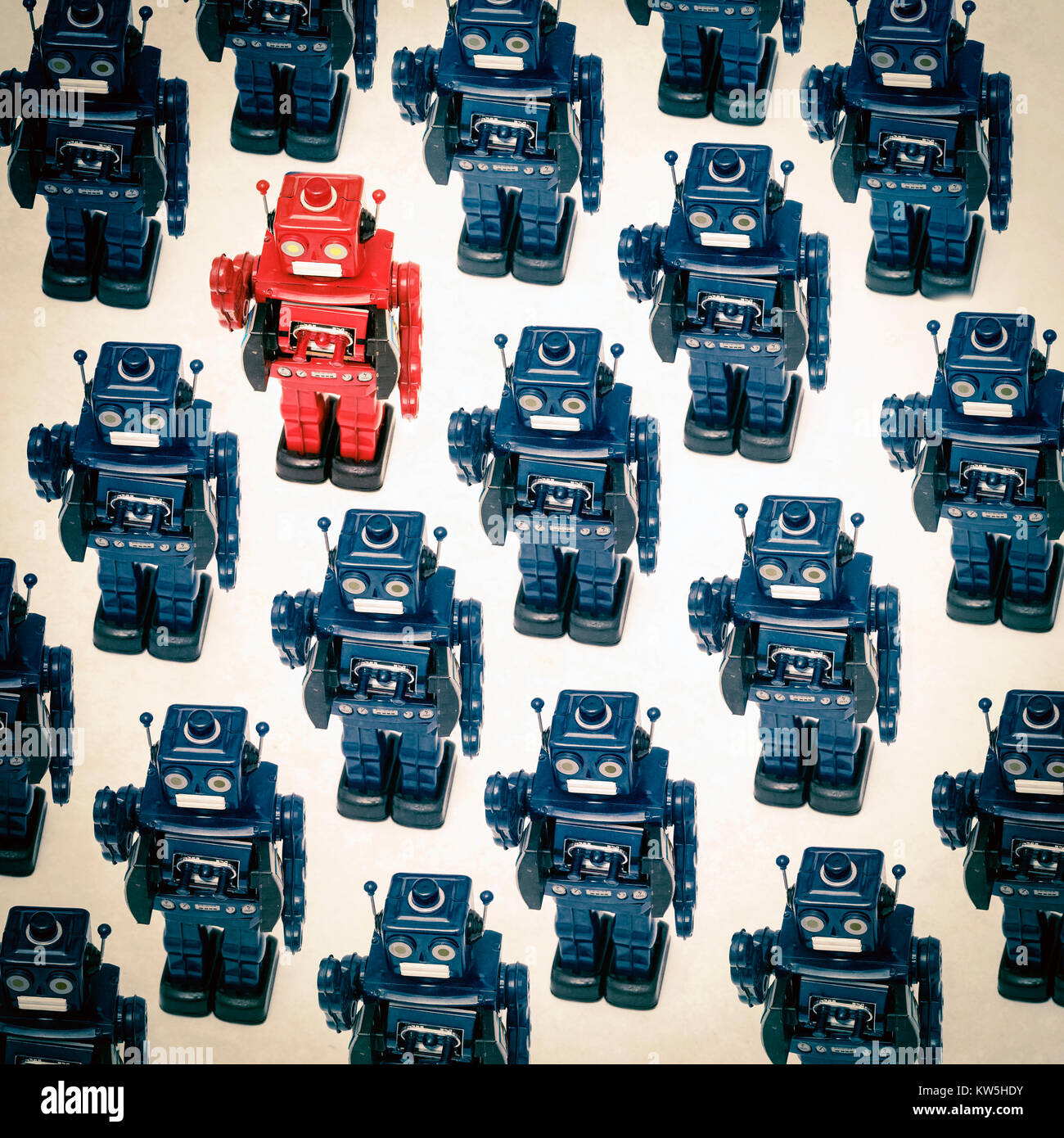 concept gong against the crowed with retro robot toys Stock Photo - Alamy