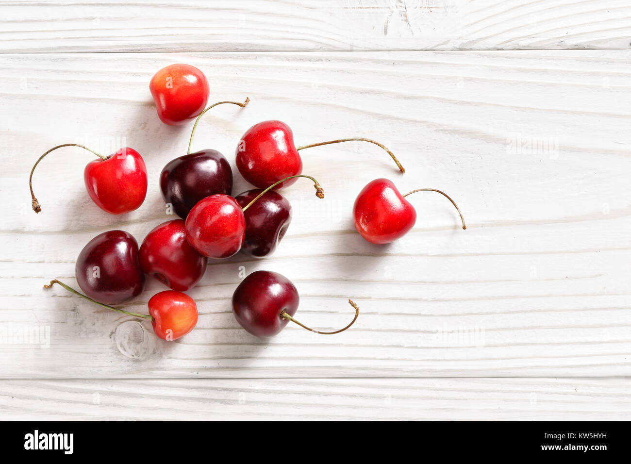 Cherry on white wooden table. Close up. Top view. High resolution ...