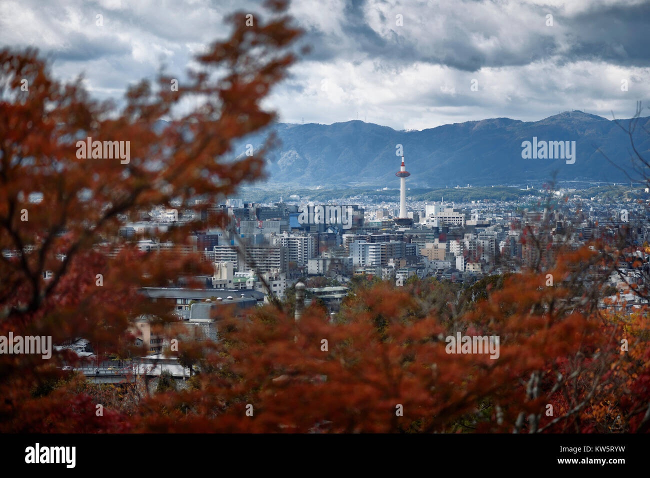 Kyoto tower under dramatic sky in aerial city scenery through red ...