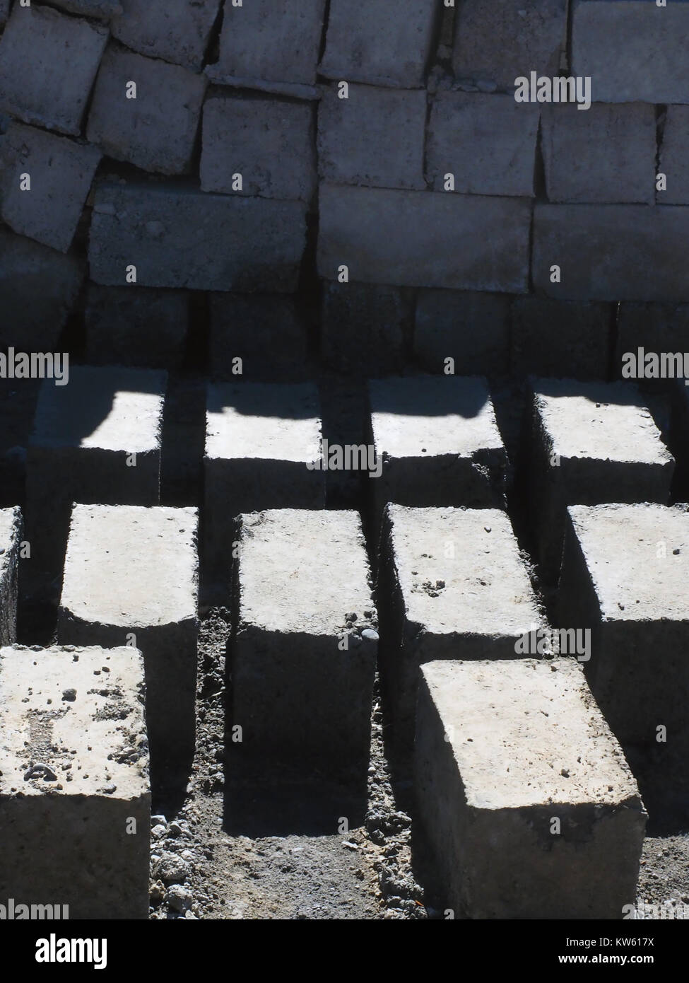 Bricks are handmade laid out on the ground to dry, in the background a ...