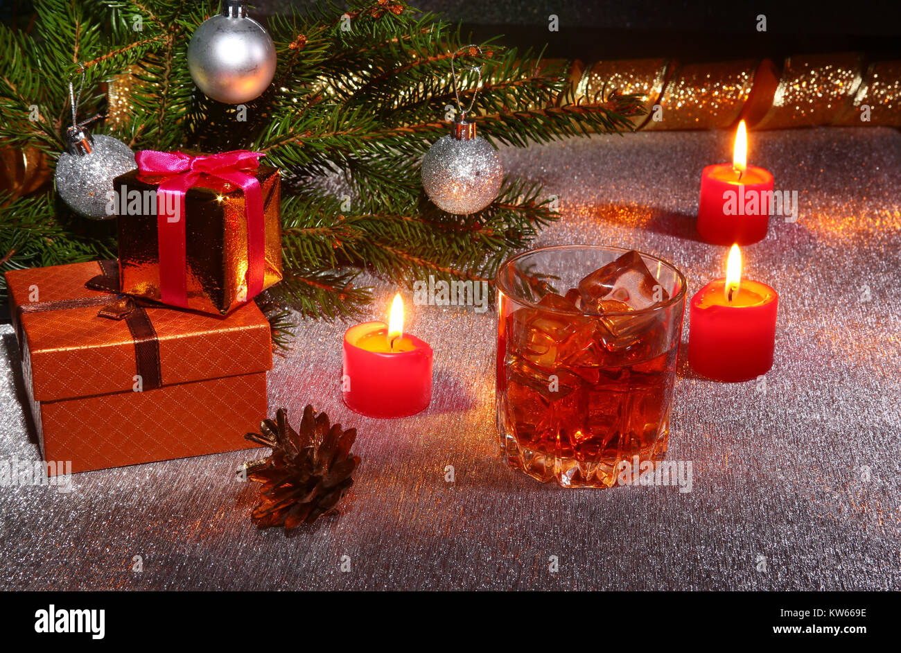 christmas decoration with glass of whiskey or cognac, christmas candles ...