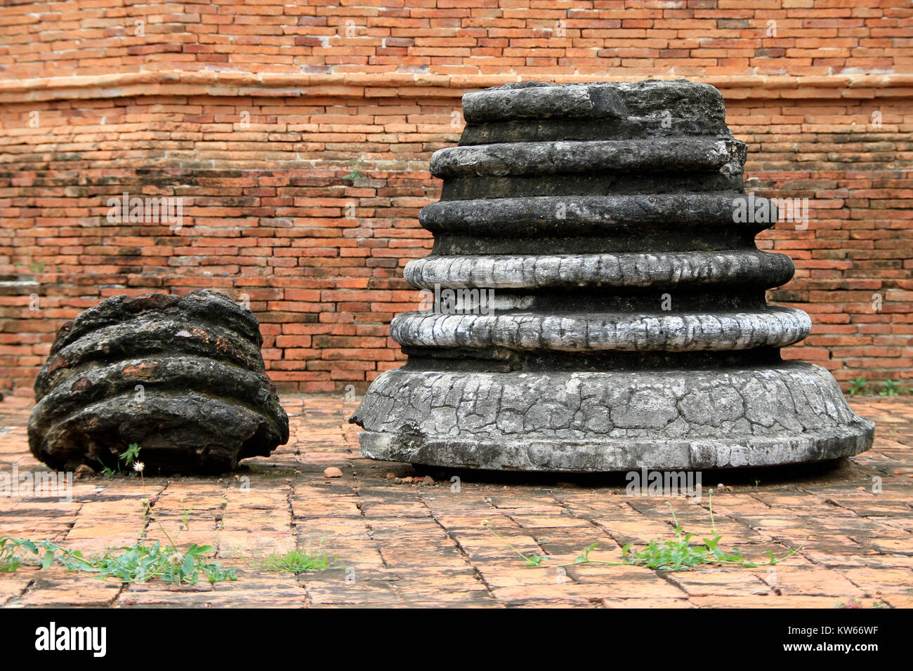 Parts of two big columns near the brick wall in temple in Ayutthaya ...