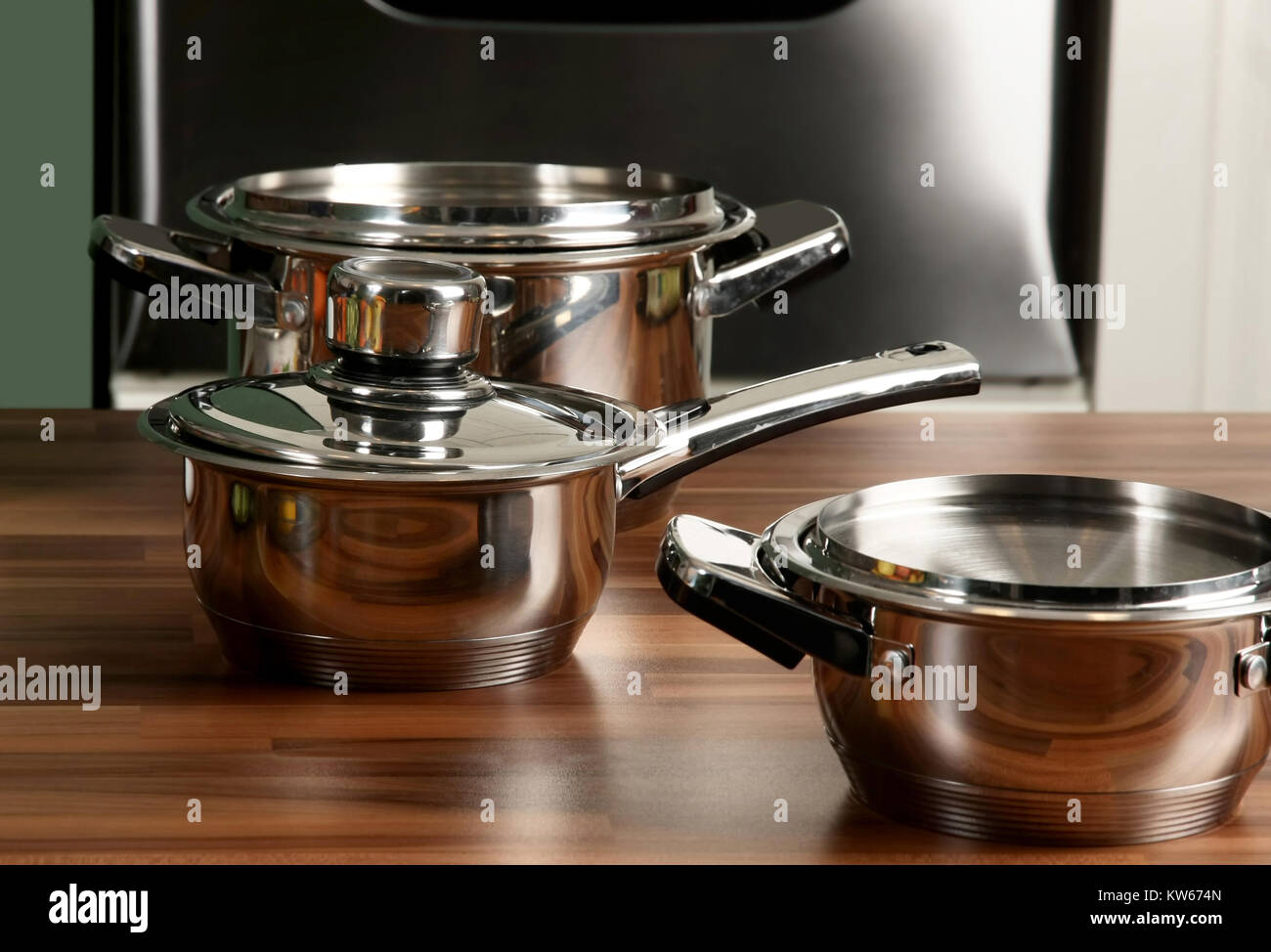 Stainless steel pot with cover in kitchen Stock Photo - Alamy