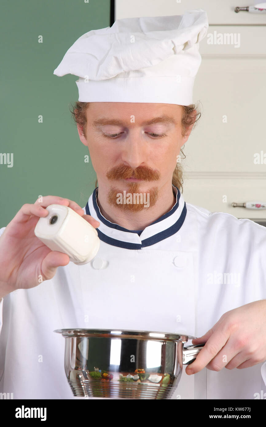 Young chef add salt in the pot, preparing lunch Stock Photo - Alamy