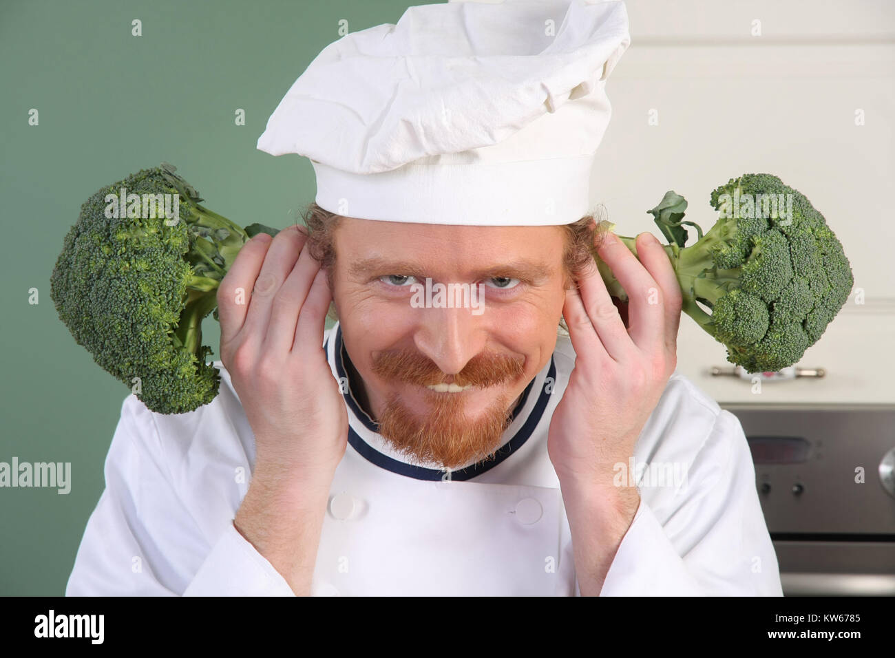 Funny young Chef with broccoli, preparing lunch in kitchen Stock Photo ...