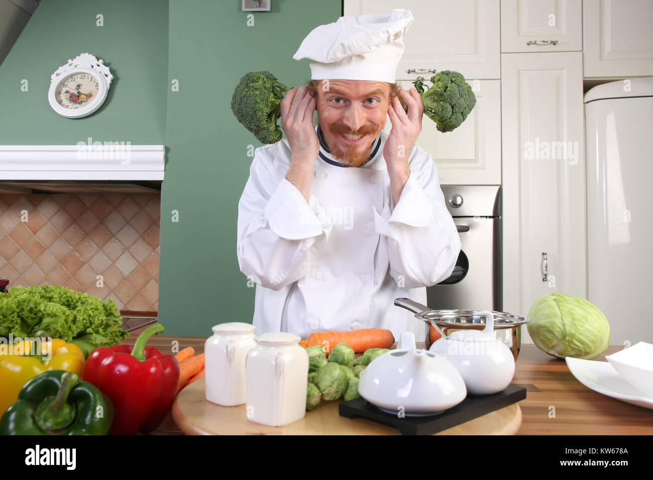 Funny young Chef with broccoli, preparing lunch in kitchen Stock Photo ...
