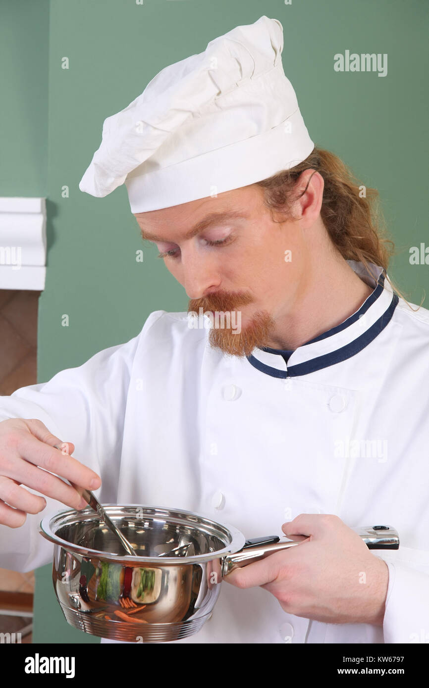 young Chef tasting food with a tablespoon Stock Photo - Alamy