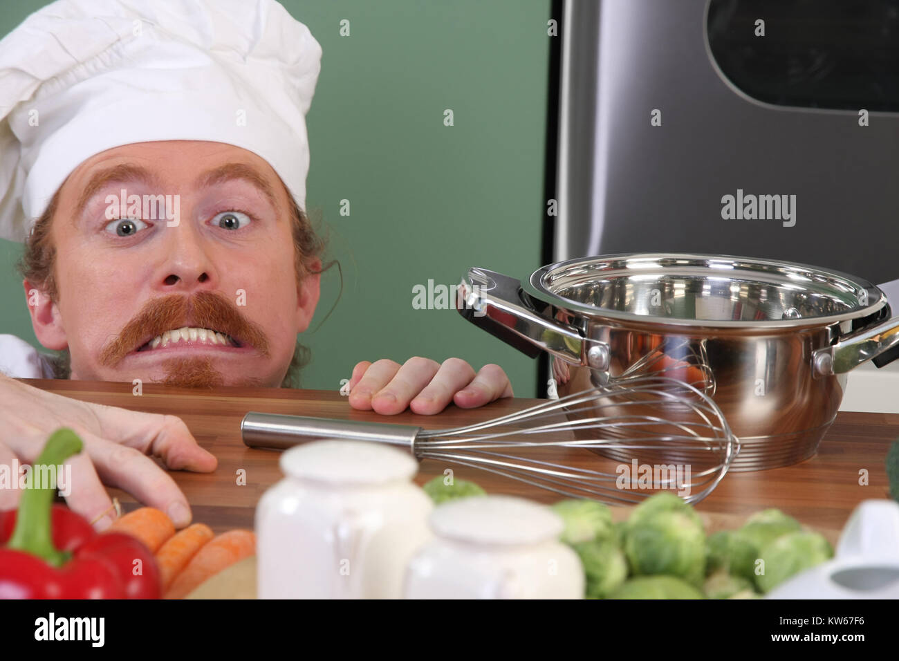 Funny young chef with a pot Stock Photo - Alamy