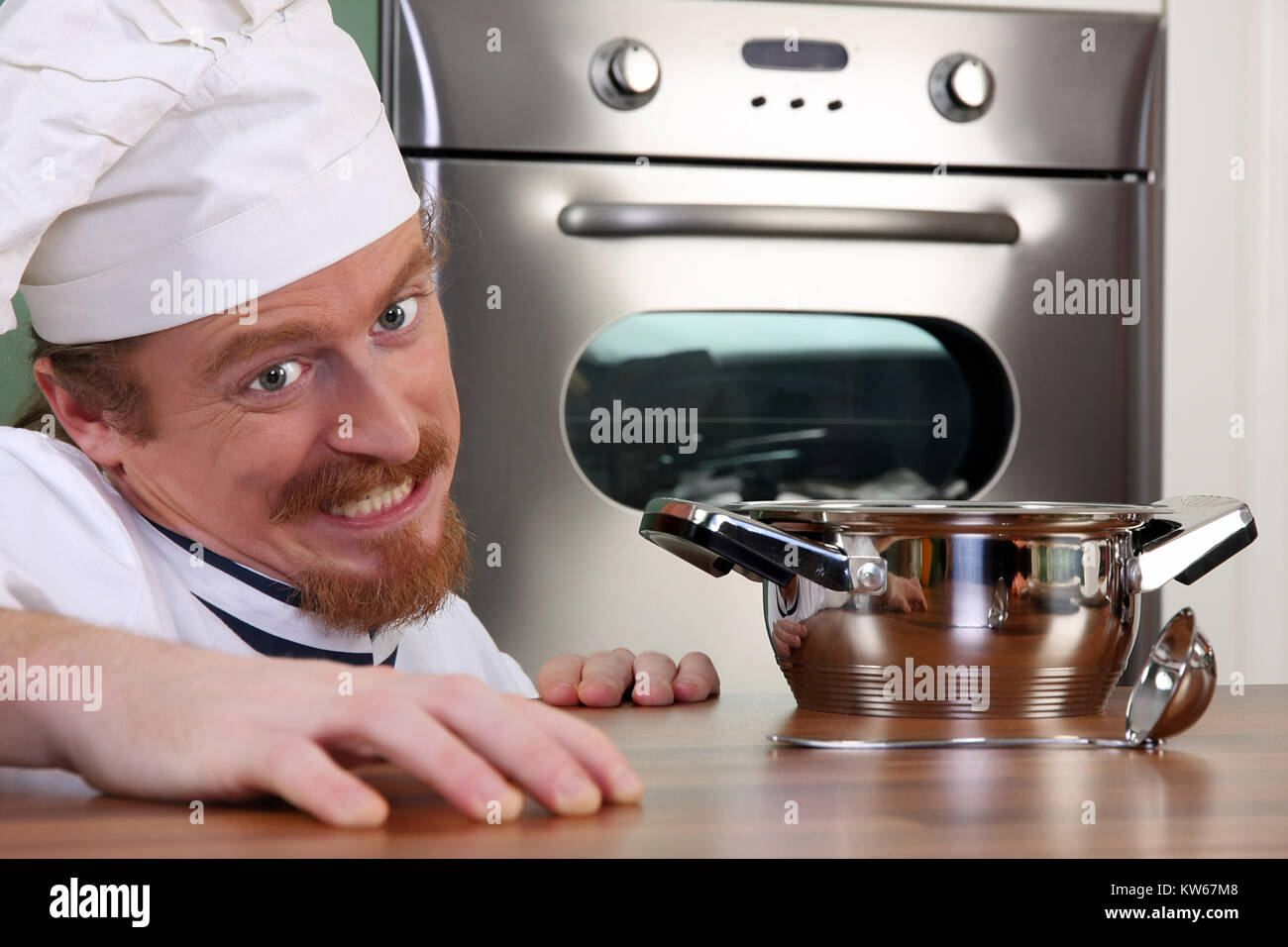 Funny young chef with a pot Stock Photo - Alamy
