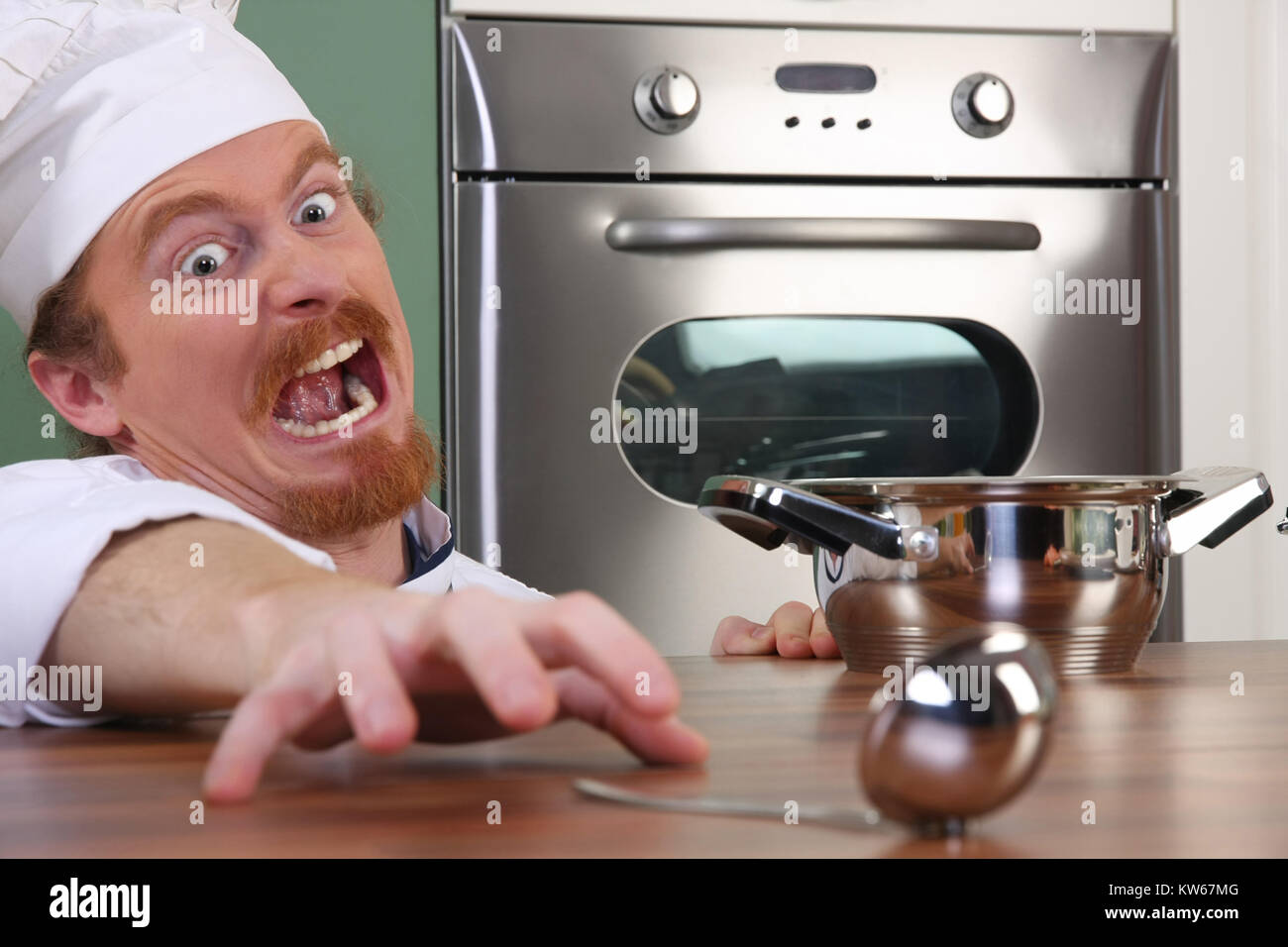 Funny young chef with a pot Stock Photo - Alamy