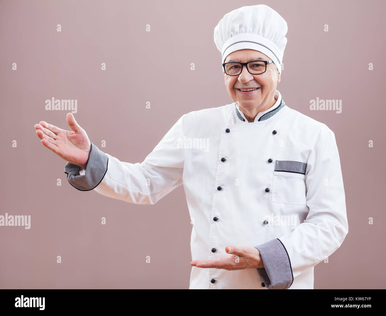 Portrait of restaurant's chef in working uniform greeting guests Stock ...
