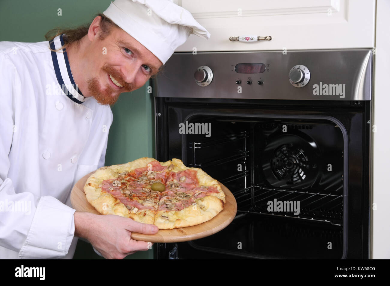 young chef with italian pizza in kitchen Stock Photo - Alamy