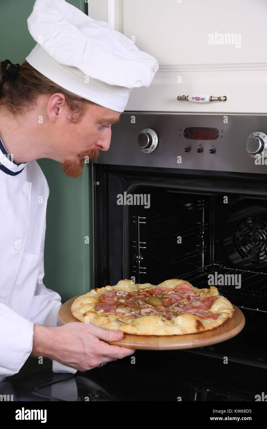 Young chef prepared italian pizza in kitchen Stock Photo - Alamy