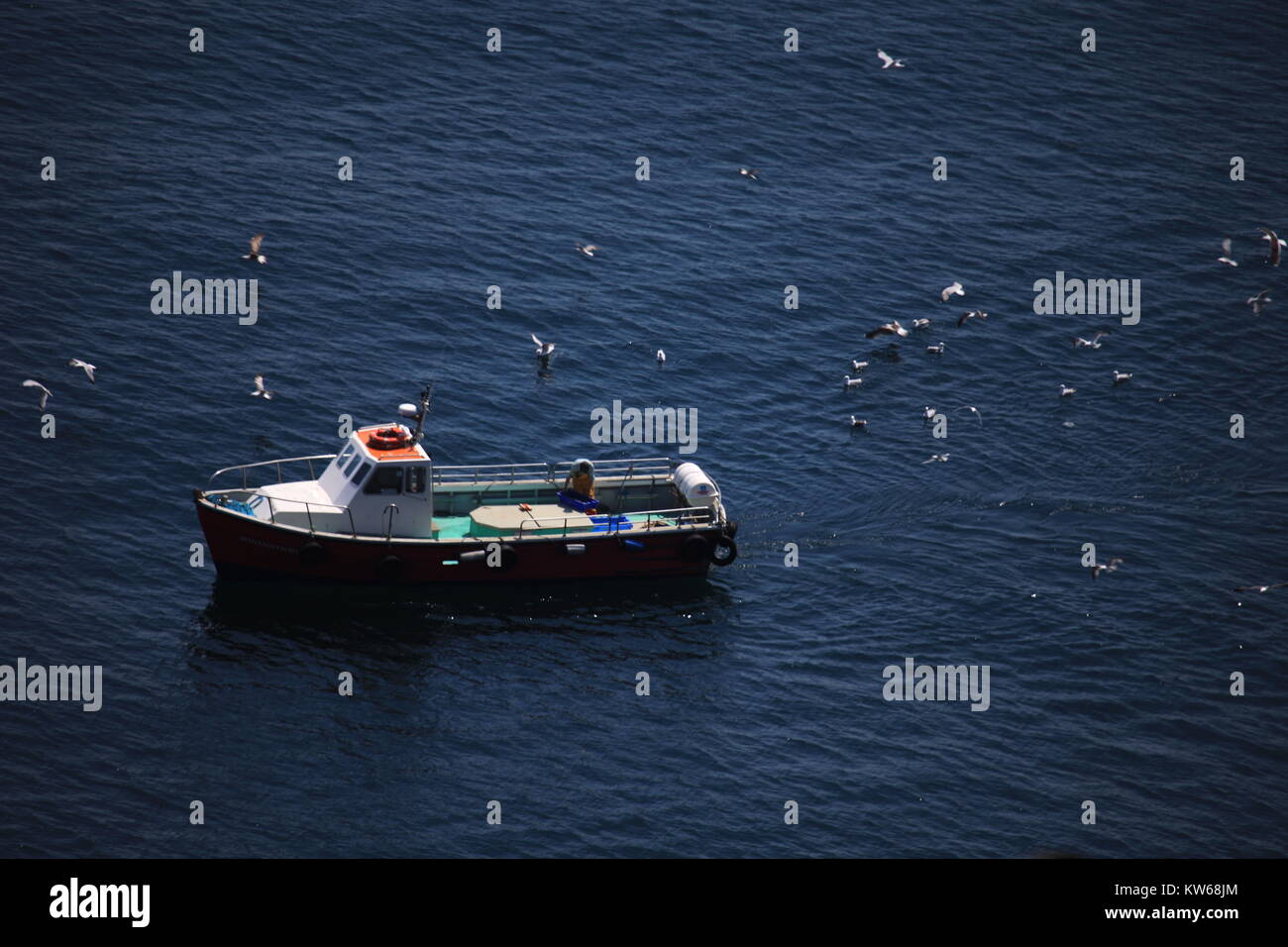 aerial image of fishing boat against deep blue sea, skellig michael ...