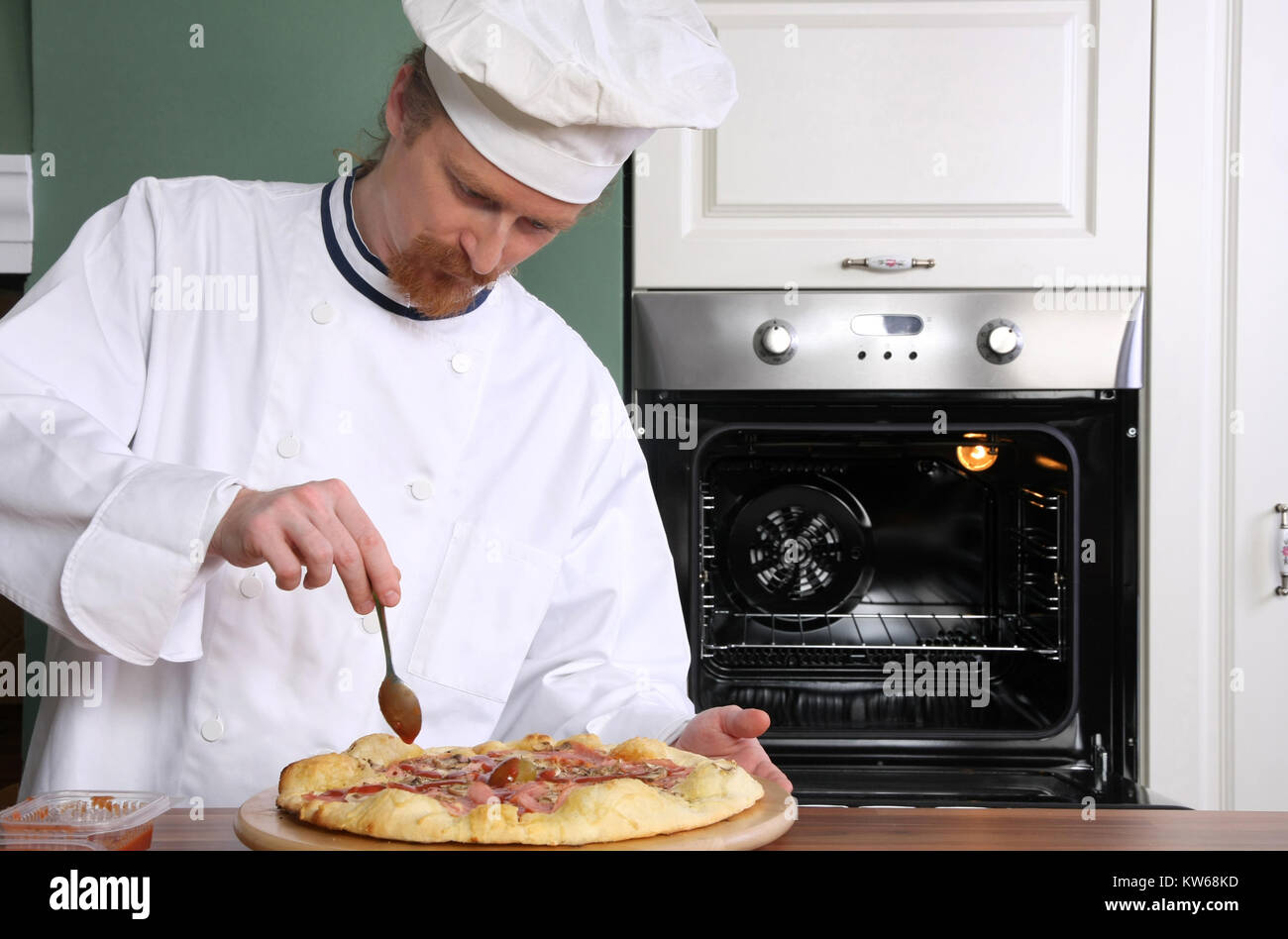 Young chef prepared italian pizza in kitchen Stock Photo - Alamy