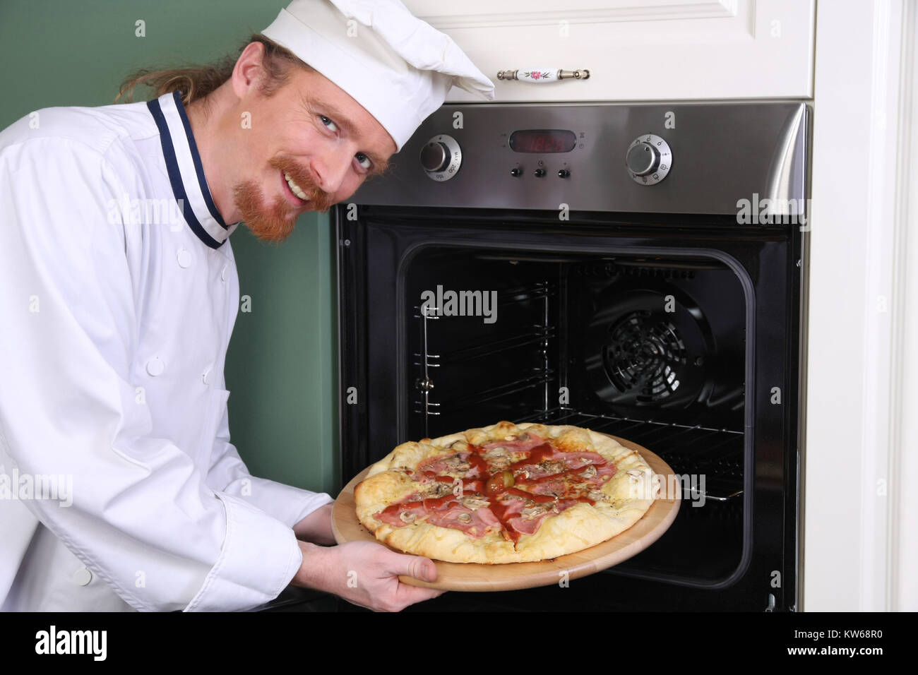 young chef with italian pizza in kitchen Stock Photo - Alamy