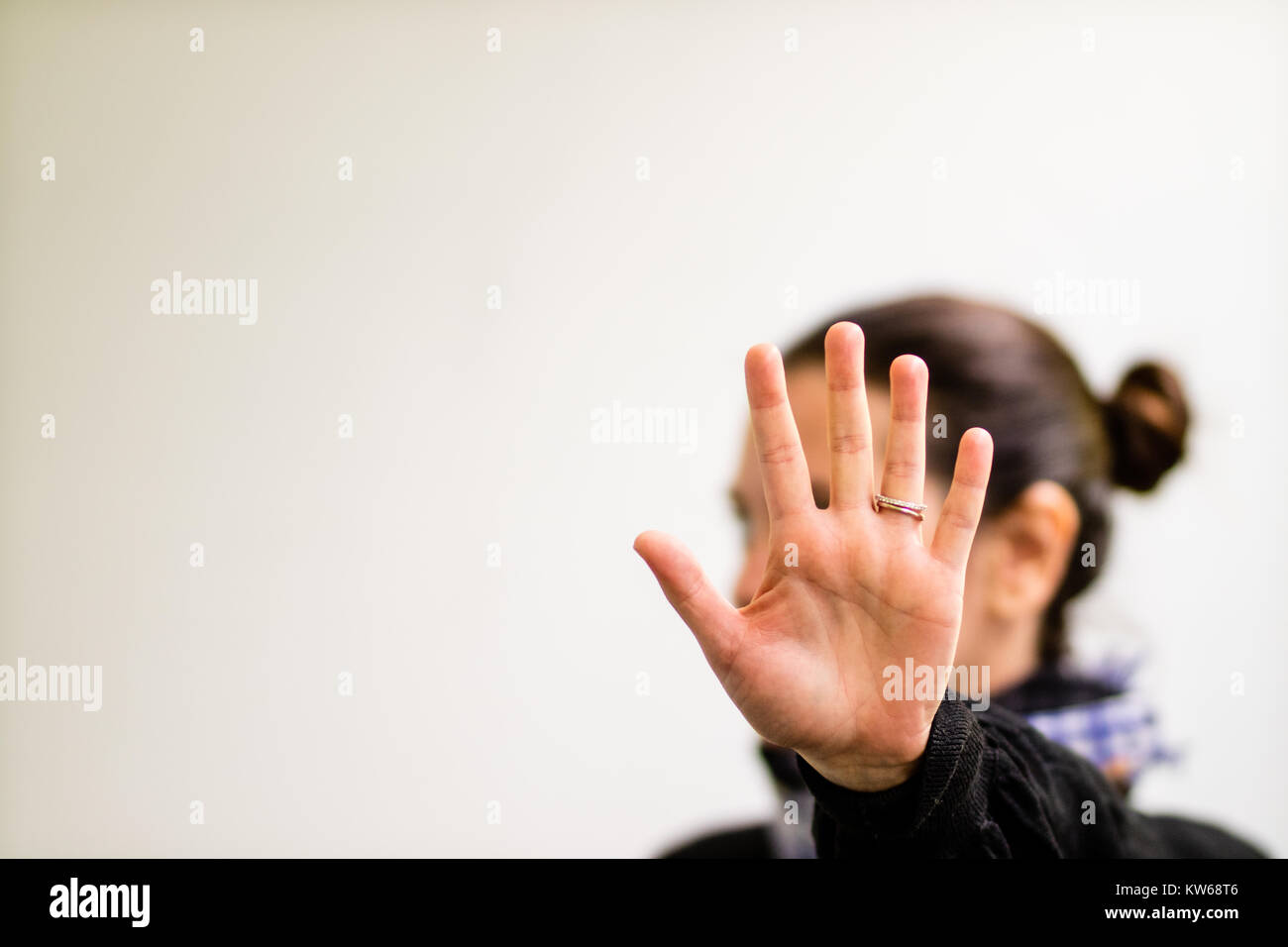 An engaged lady showing her palm to the camera, a clear sign of ...