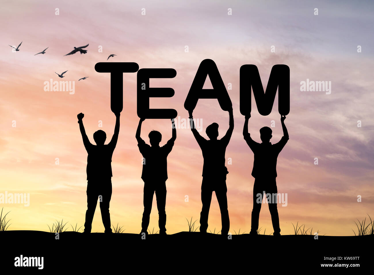 Silhouette of Businessmen holding team words in sunset , concept as ...