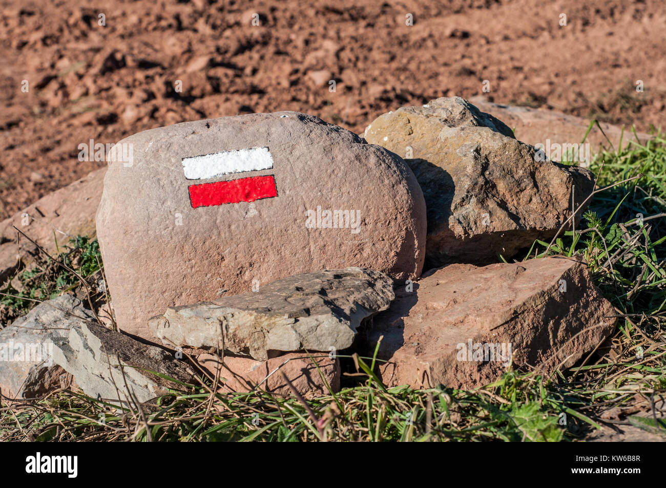 Stone landmark, sign with two horizontal lines, red and white to ...