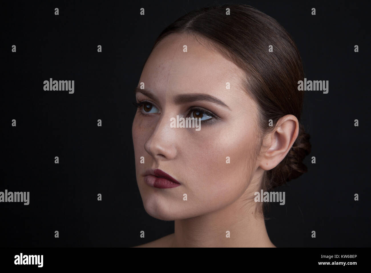 Woman with make-up on one side of the face and without make-up on the ...
