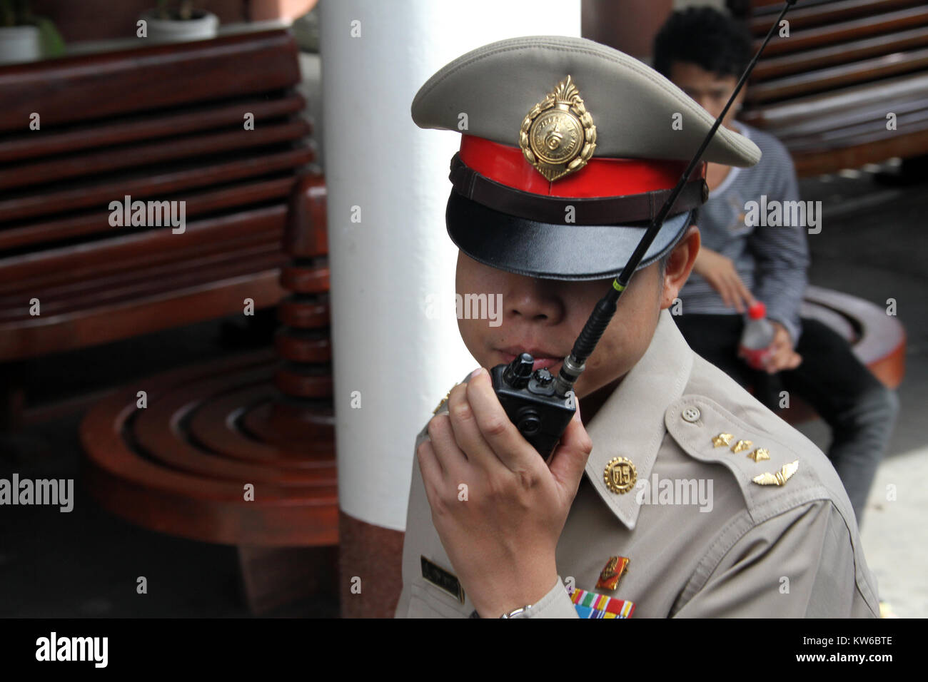 Railwayman with radio on the platform in Thailand Stock Photo - Alamy