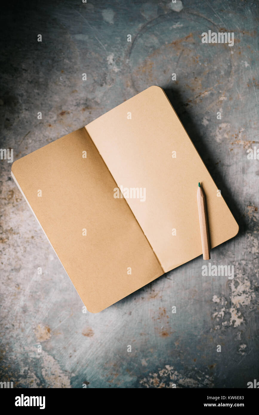 Little brown notepad on metal surface Stock Photo - Alamy