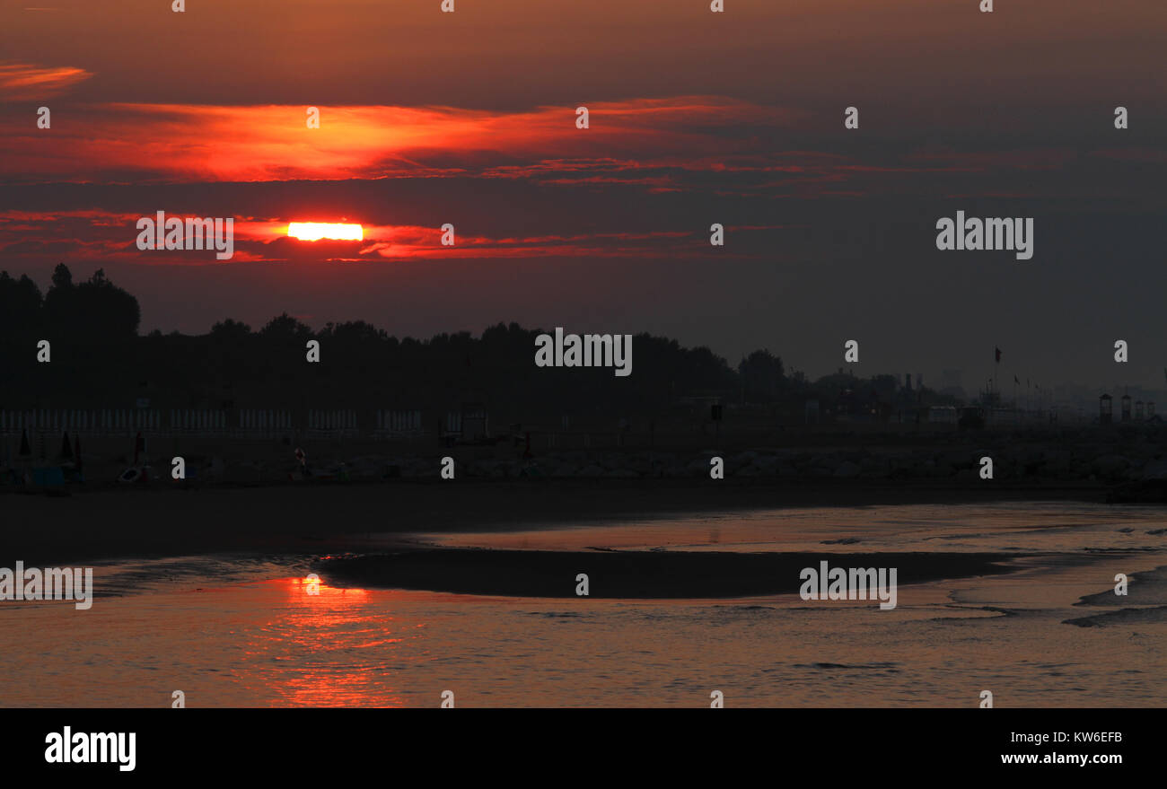 great sunrise with the red sun and the reflection on ocean Stock Photo ...