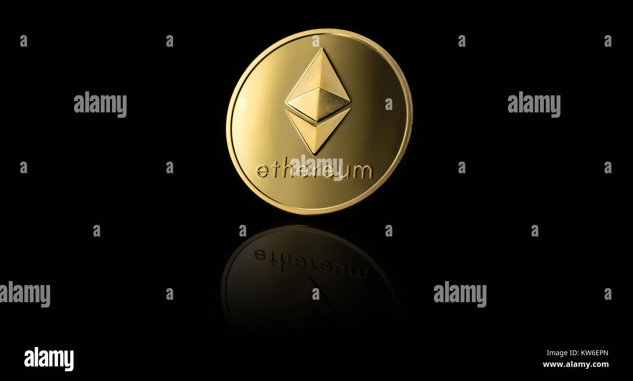 Golden ethereum coin on black background Stock Photo - Alamy