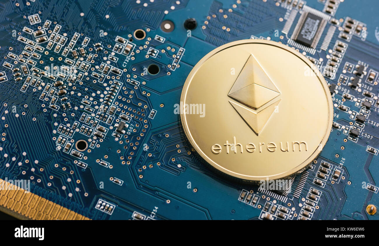 Golden ethereum coin cryptocurrency on a computer mainboard Stock Photo ...