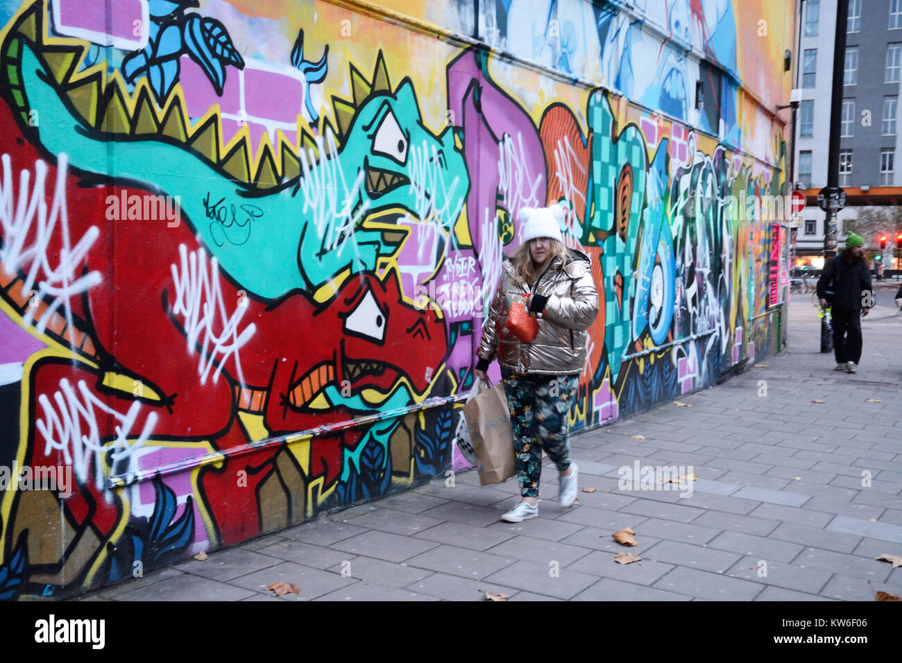 People walking by Graffiti, in Bristol Stock Photo - Alamy