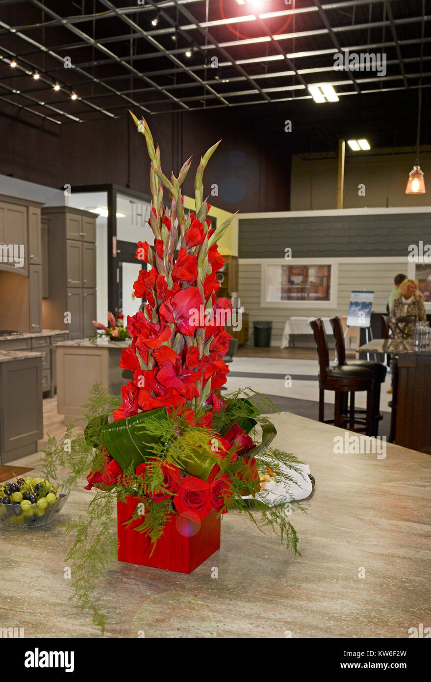 Red flower arrangement in a professional setting Stock Photo - Alamy
