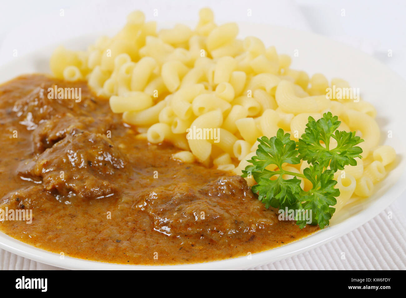plate of beef goulash with cooked macaroni Stock Photo - Alamy