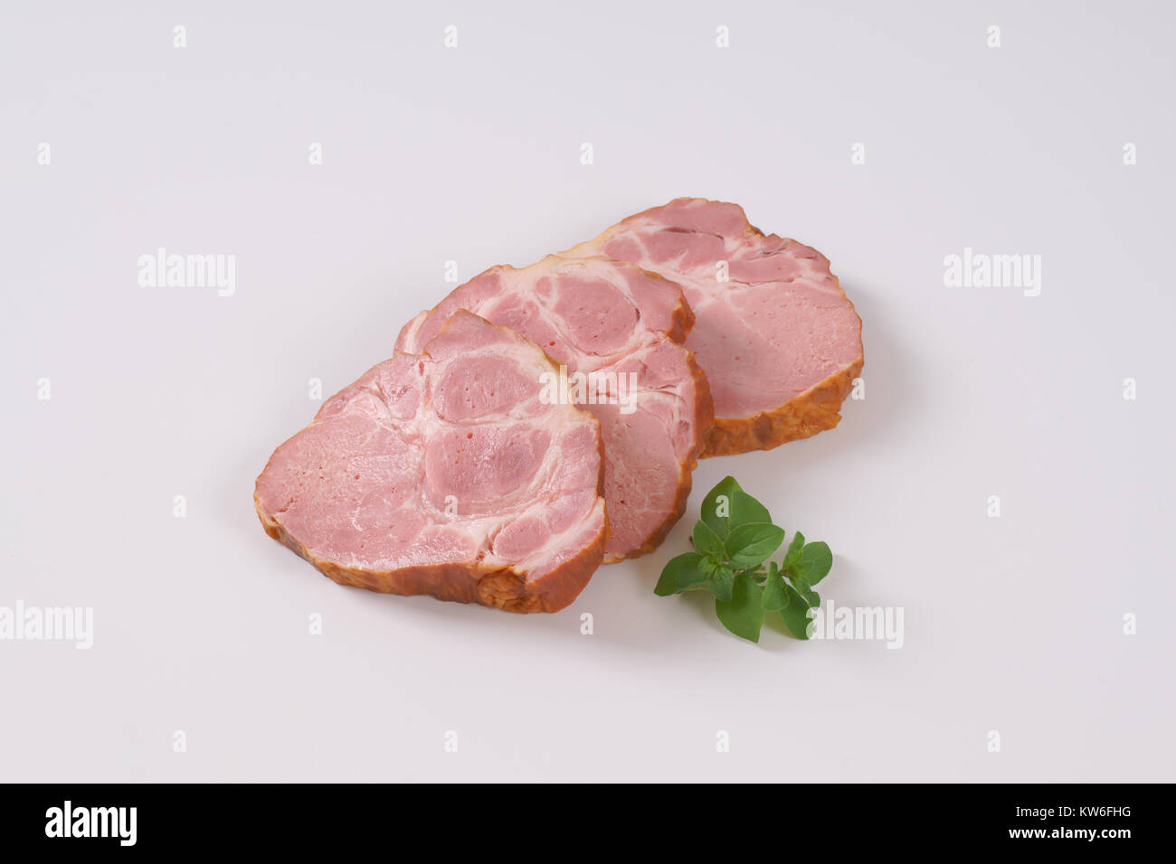 slices of smoked pork neck on white background Stock Photo - Alamy