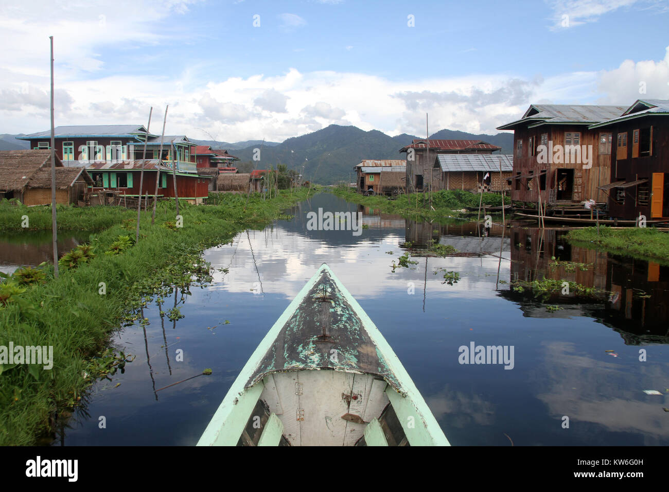 Boat and wooden houses on the Inle lake, Myanmar Stock Photo - Alamy