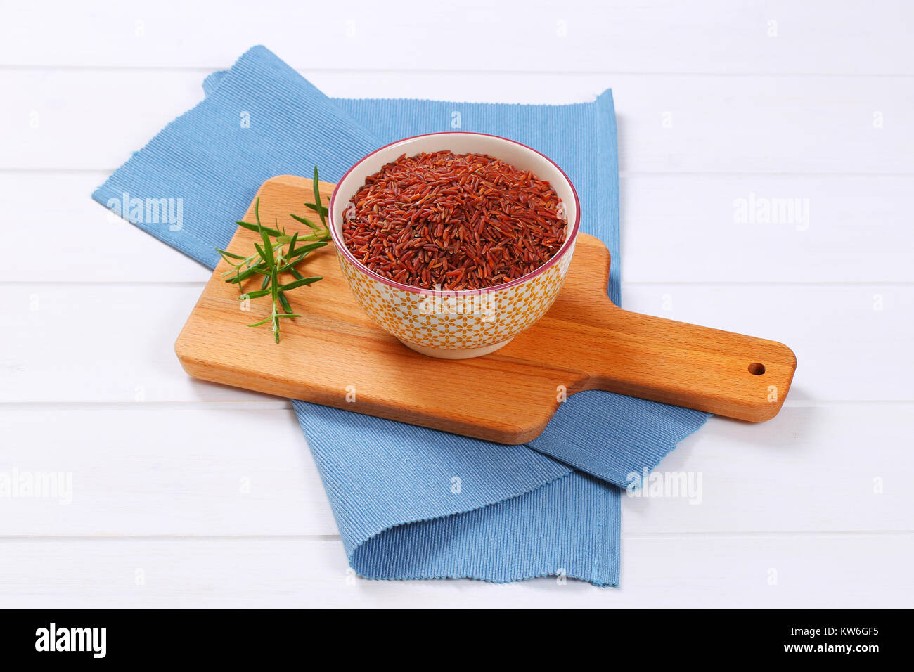 bowl of red rice on wooden cutting board Stock Photo - Alamy