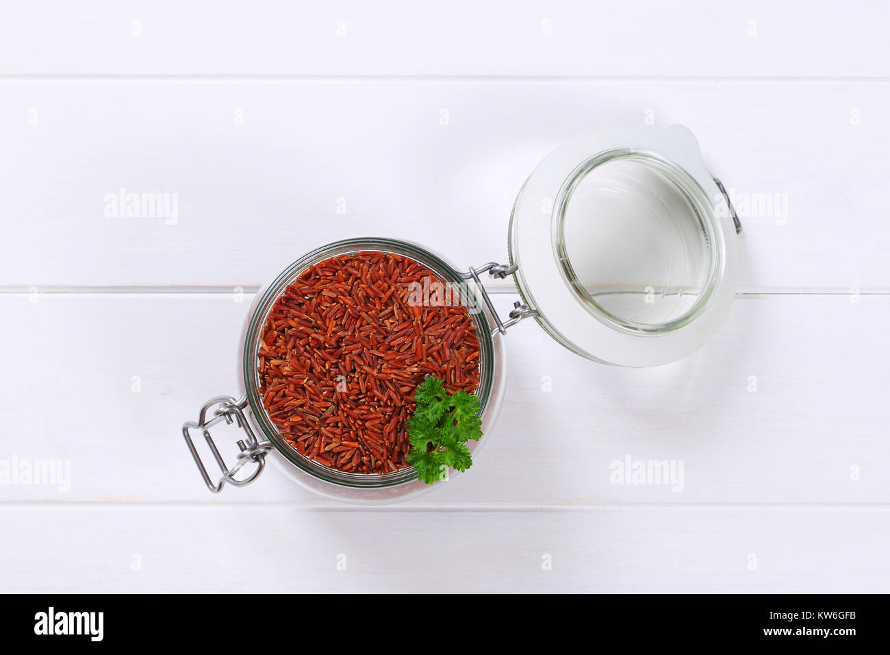 jar of red rice on white wooden background Stock Photo - Alamy