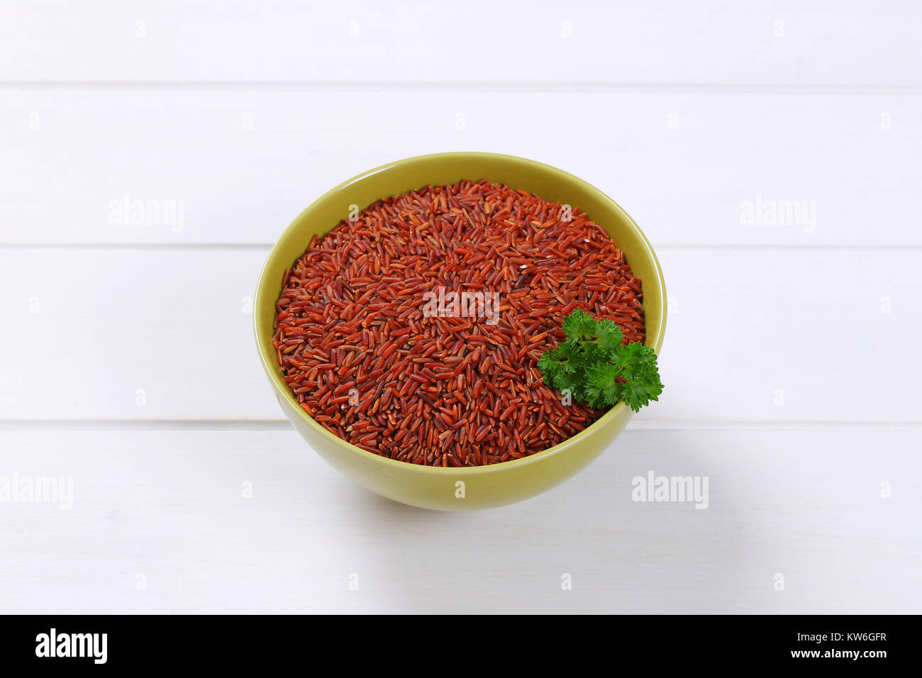 bowl of red rice on white wooden background Stock Photo - Alamy