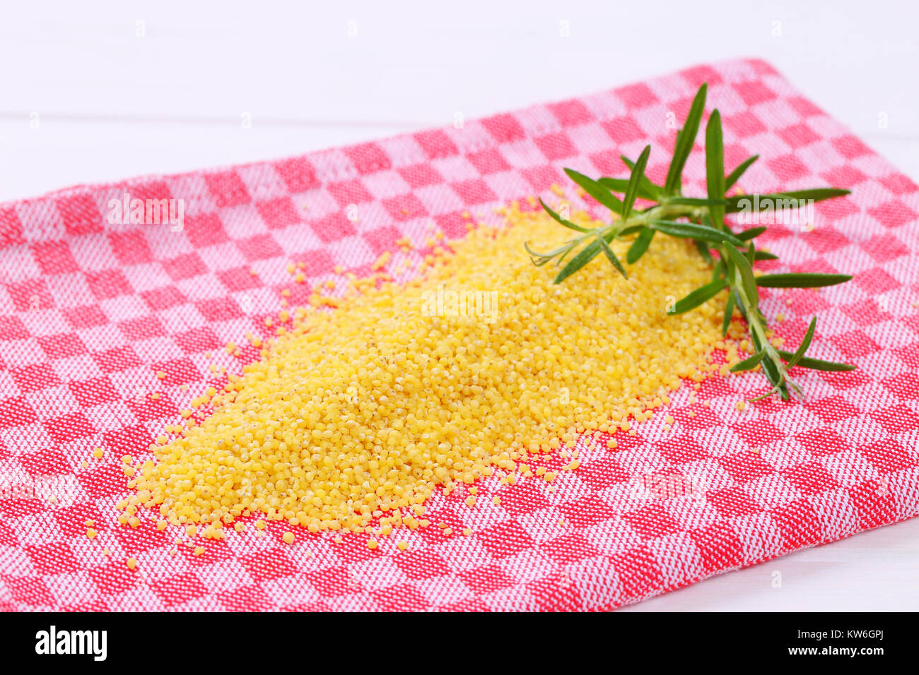 pile of raw millet on checkered place mat - close up Stock Photo - Alamy