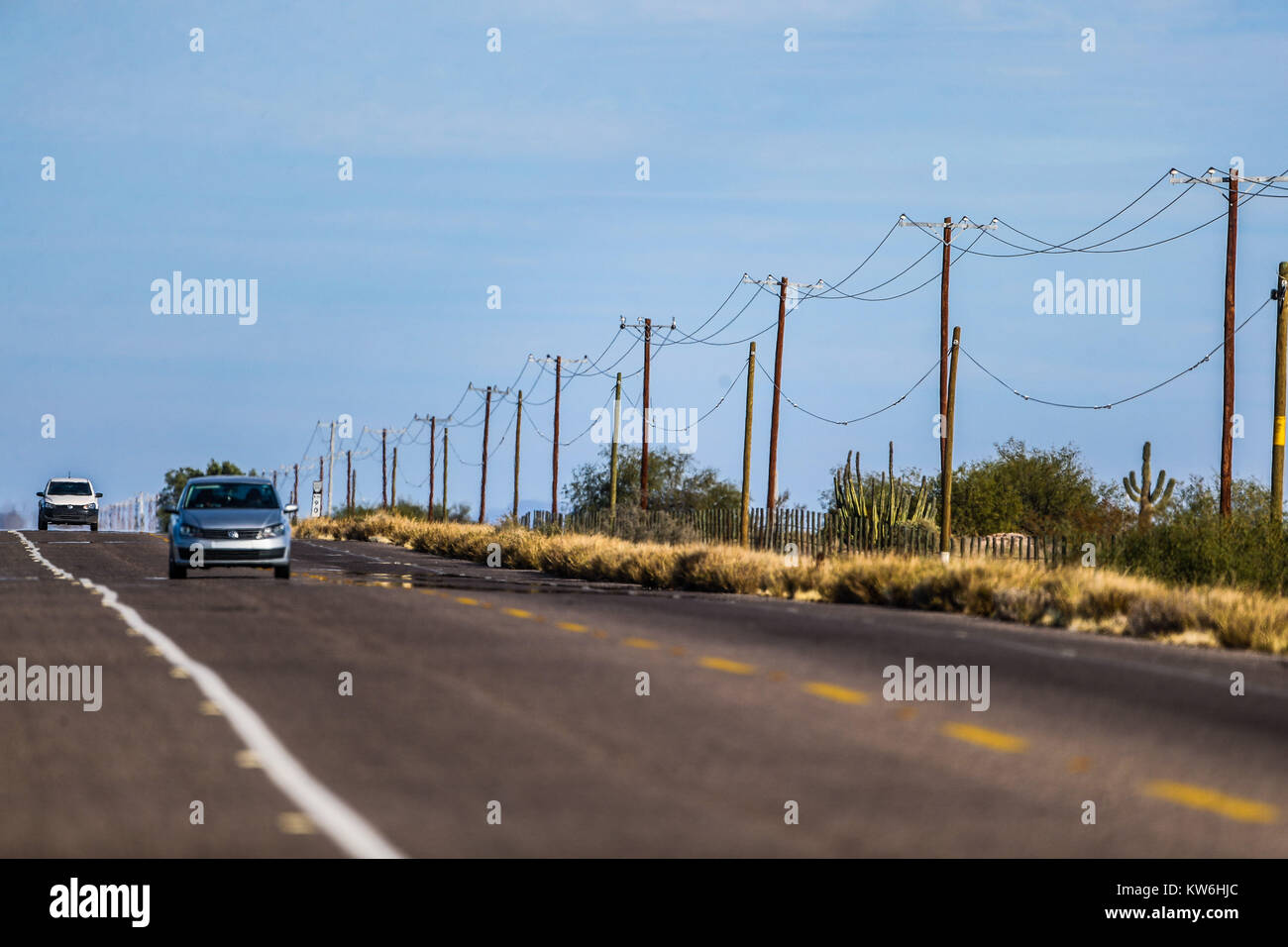 Road, towers and electric light poles crossing the landscape and ...