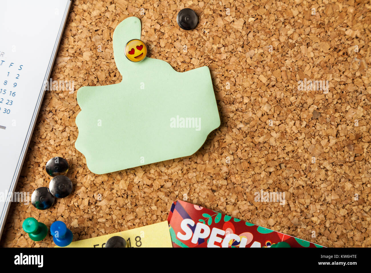 Blank Thumbs up shaped Note on cork notice board with yellow pin Stock ...