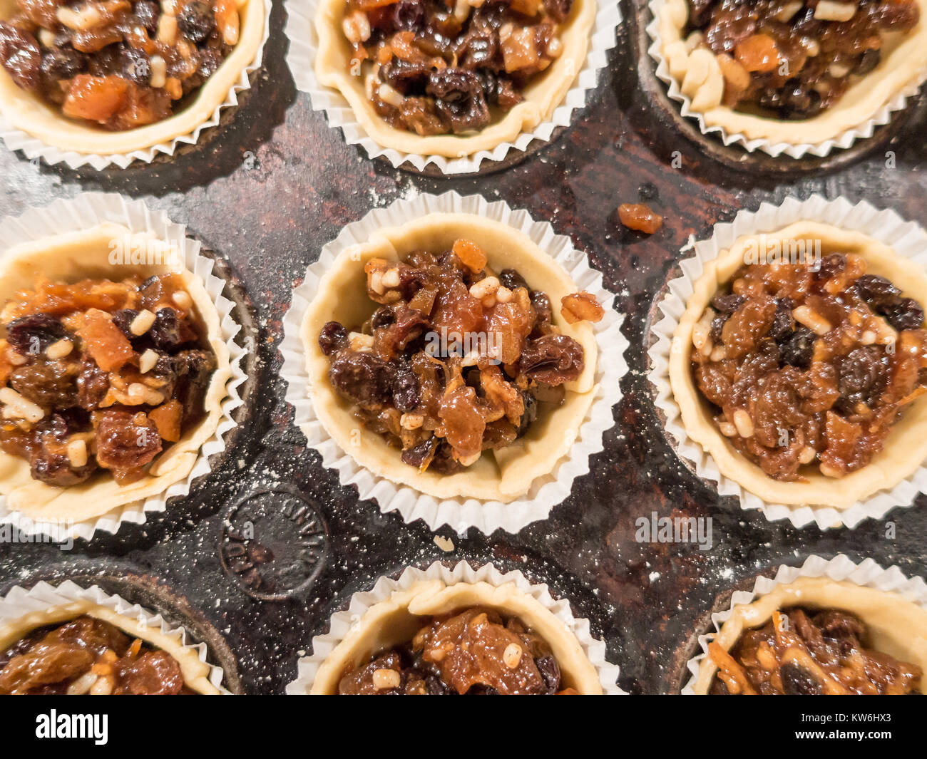 Making Mince Pies: Mince pies in a baking tray. Circles of pasty have ...