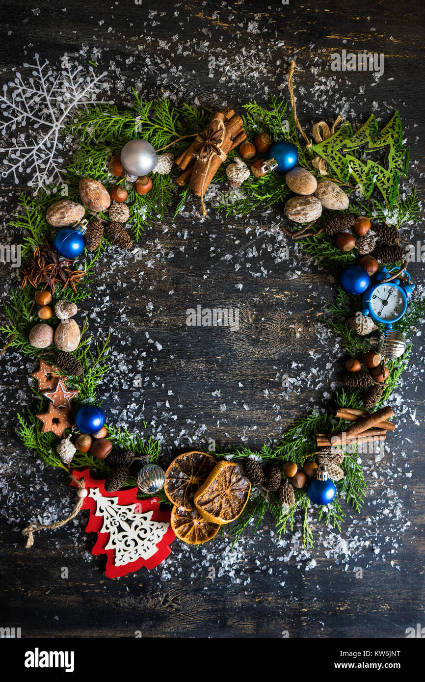 Christmas frame with fir tree branch, red berries and decorations on ...