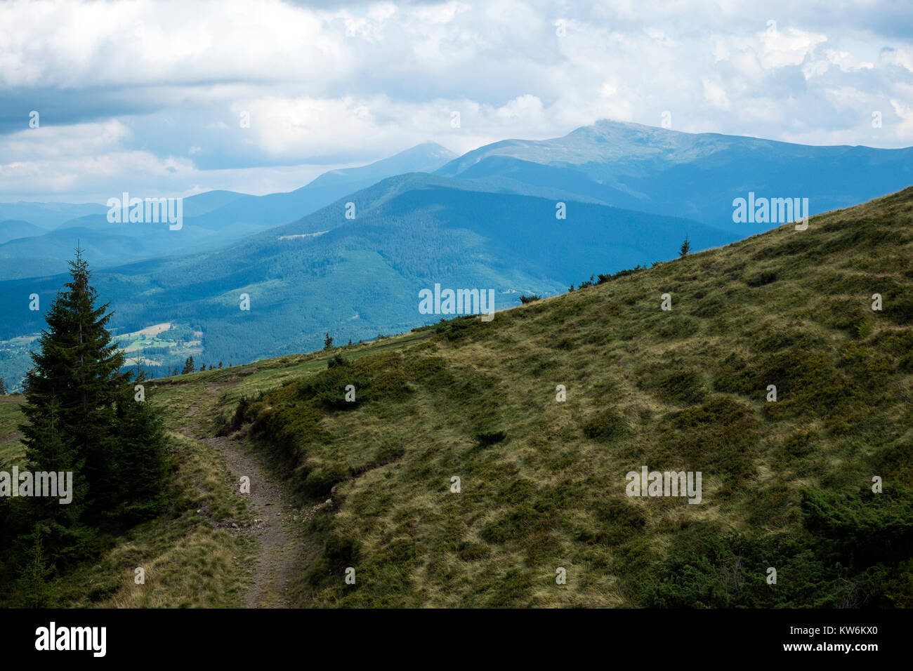 Narrow mountain path against the backdrop of the peaks of the ...