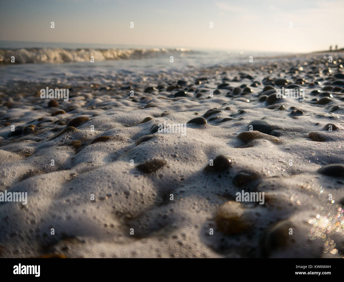 Surf breaking on pebbles Stock Photo - Alamy
