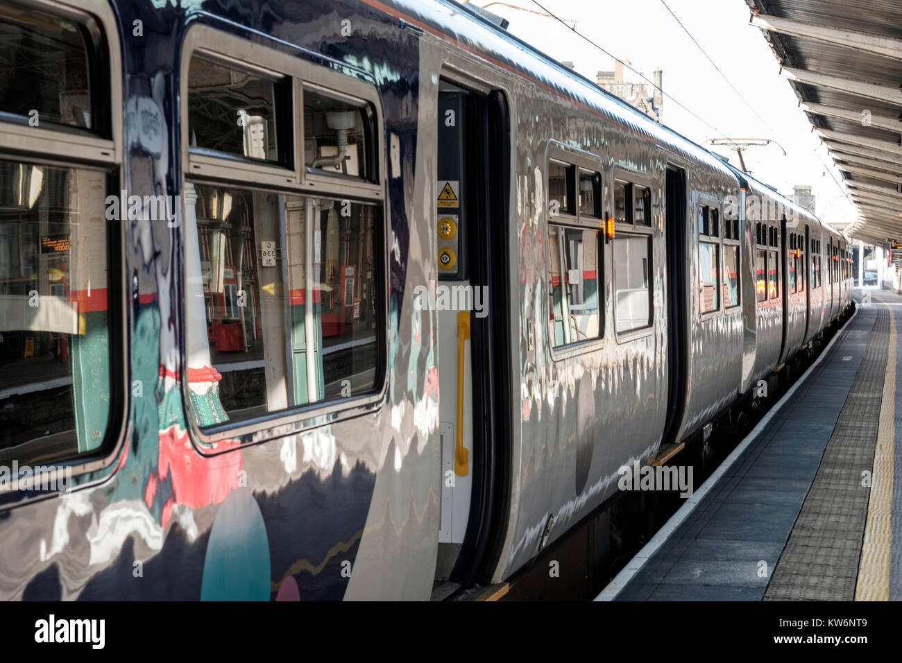 A passenger train waits at the platform Stock Photo - Alamy