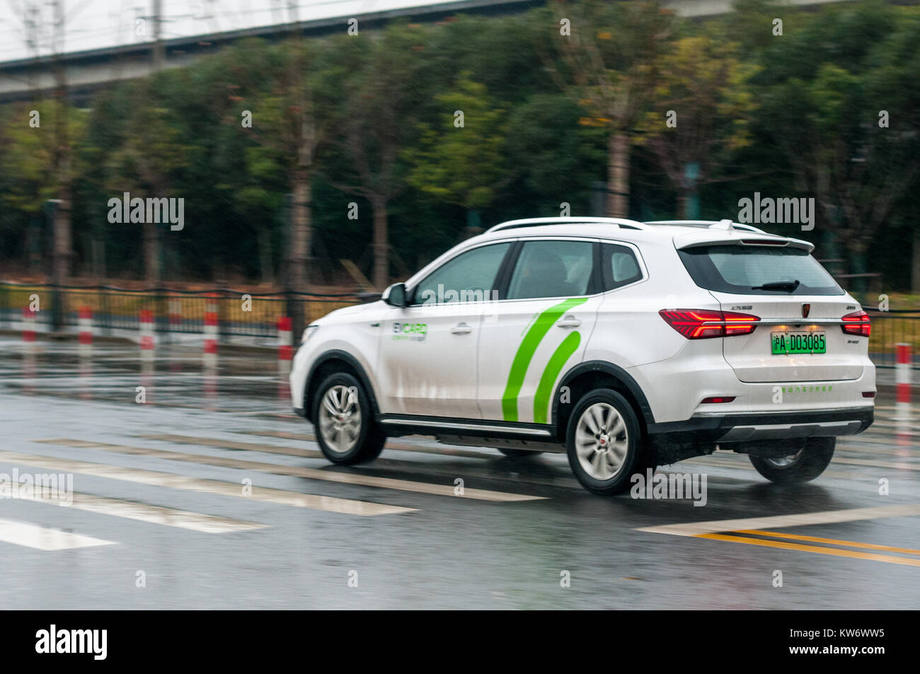 Moving shot of SAIC’s Roewe eRX5 EV400 battery electric car being driven in Pudong as offered by ...