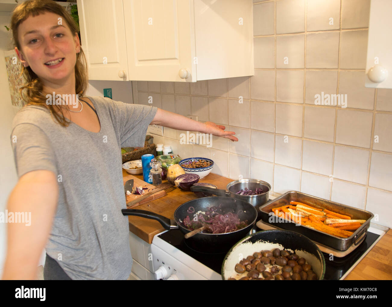 Model released : Young woman proud of cooking her vegan family ...