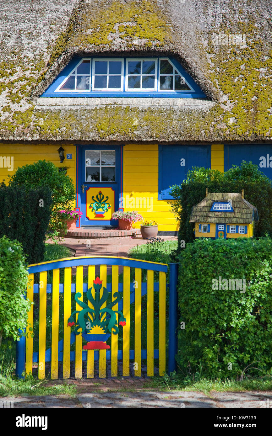 Colourful thatched-roof house with postbox (miniature replica of house ...